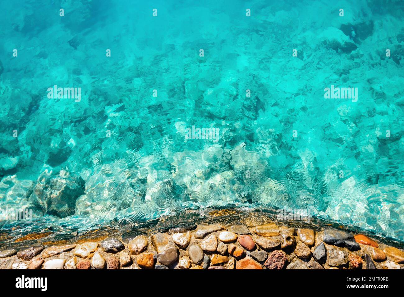 The transparent blue sea and beautiful stone shore. Background Stock ...