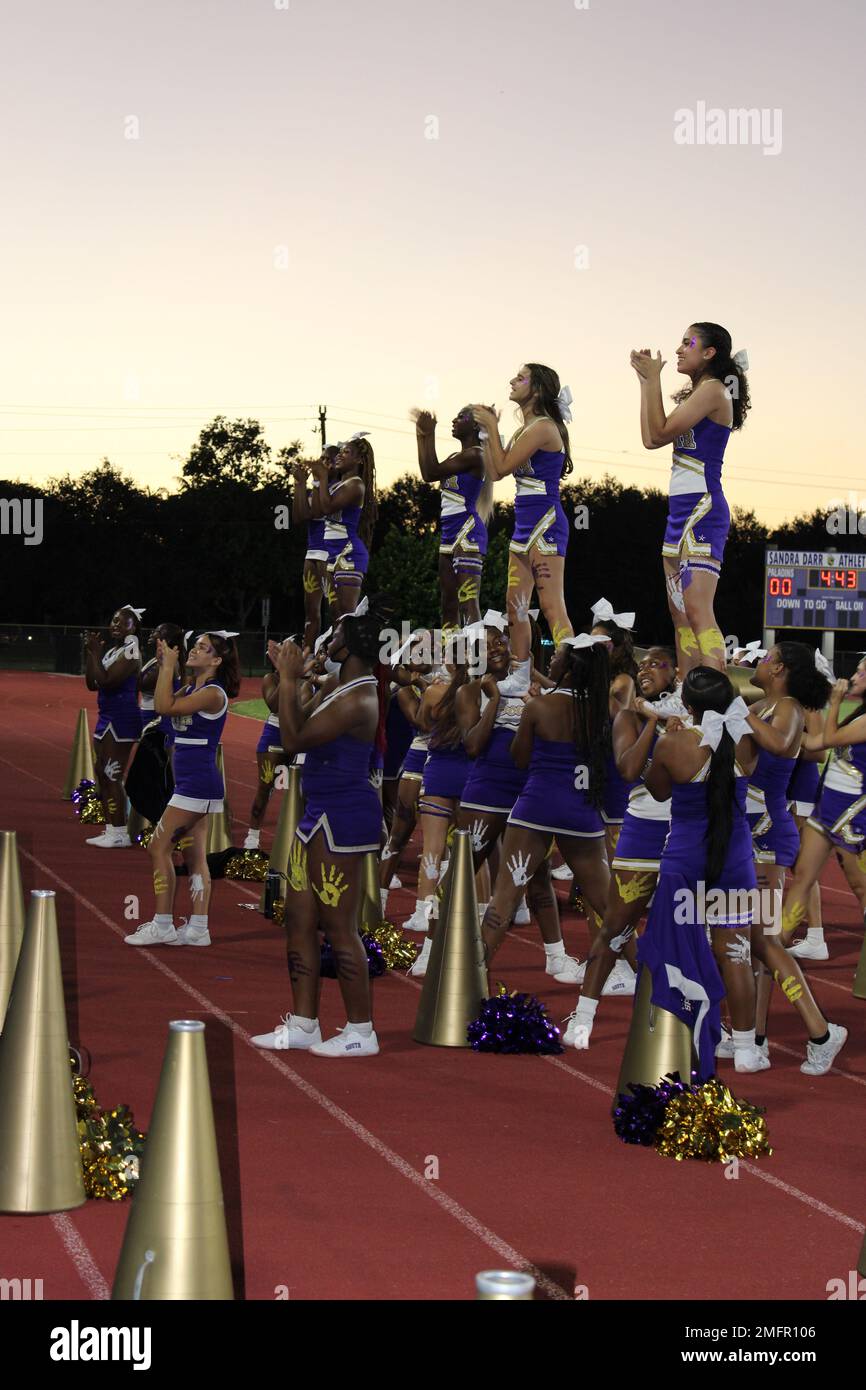 A cheerleading squad cheering for their team Stock Photo - Alamy