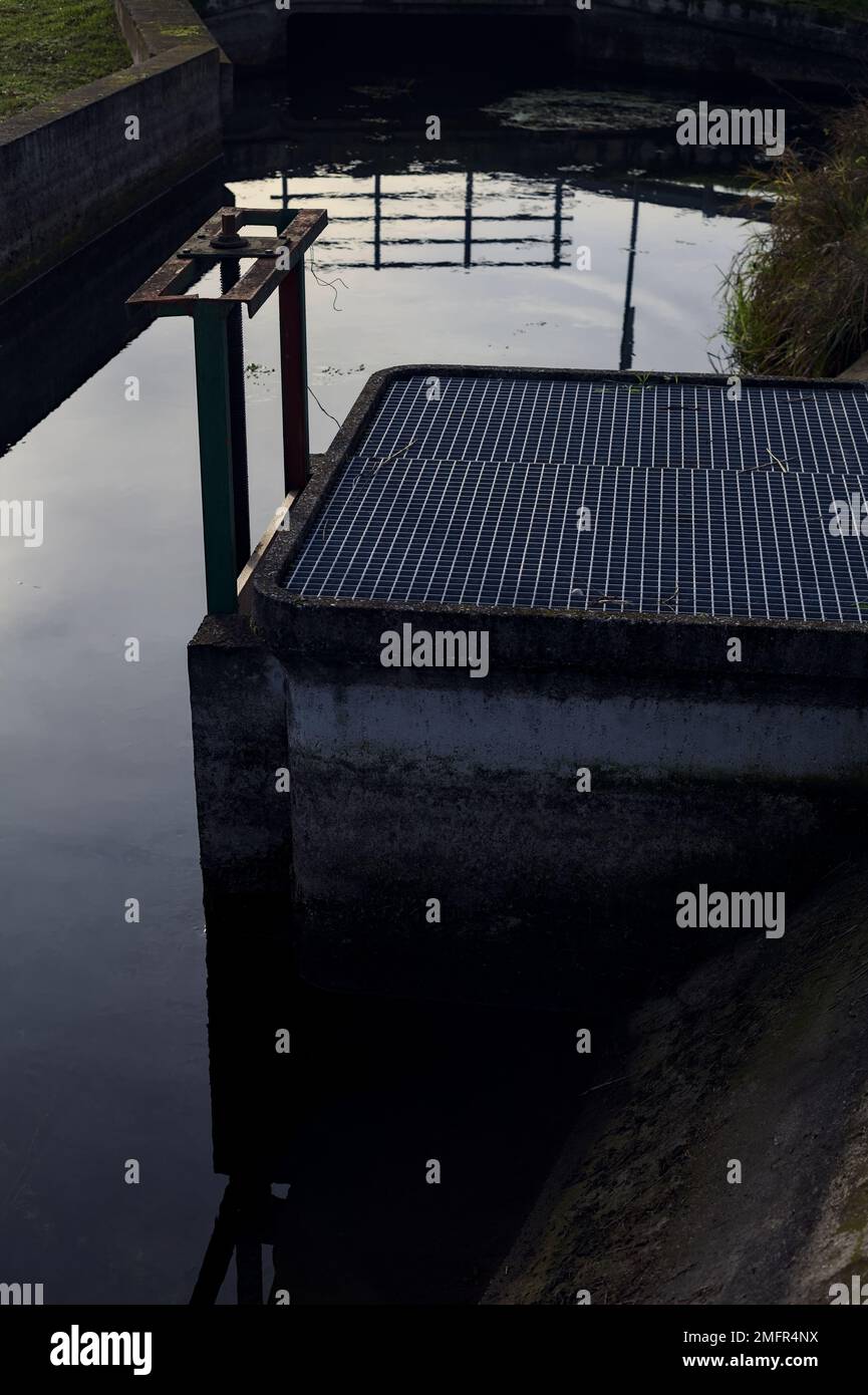 Weir in a body of water and reflection of the sky casted in it Stock ...