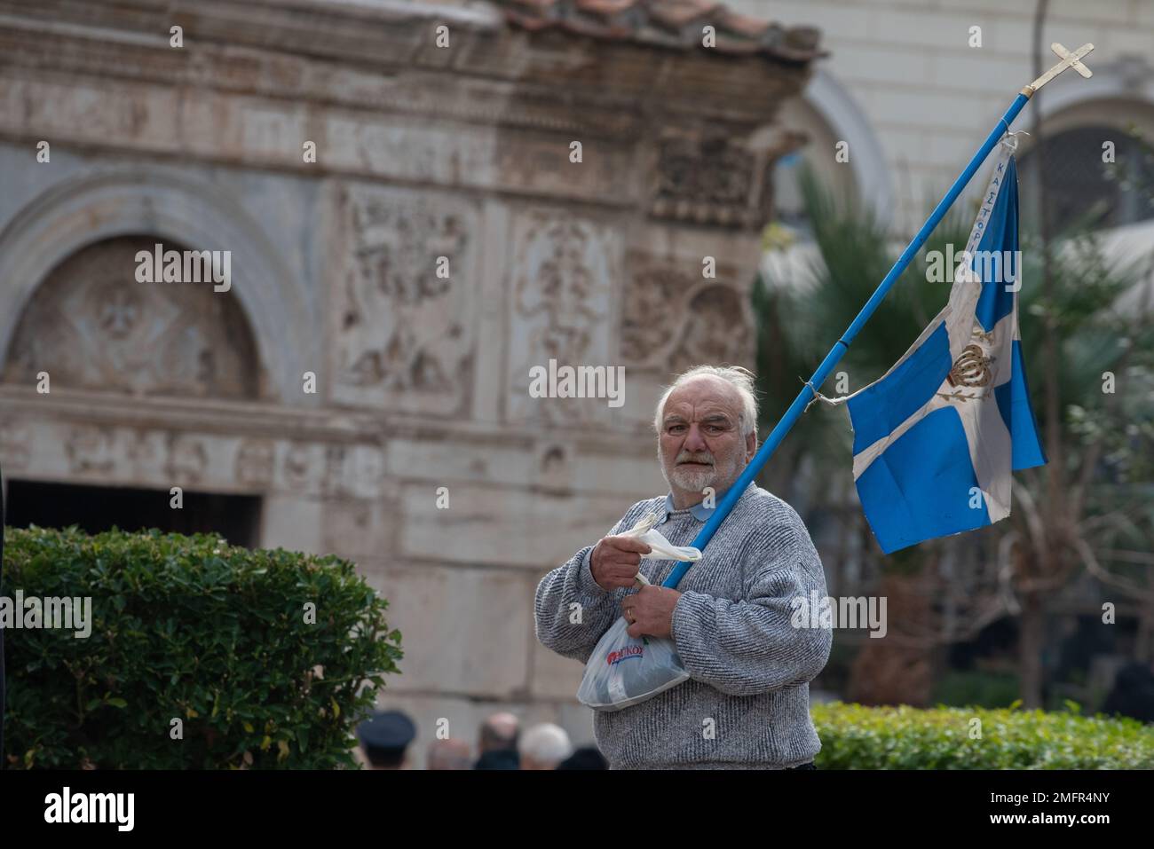 Athens, Greece. 16th January 2023. A man holds a Greek flag with crown ...
