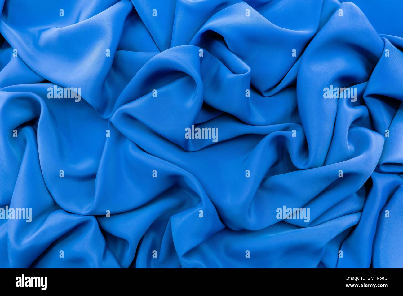 The texture of a smooth luxurious, elegant fabric in blue. Blue satin ...