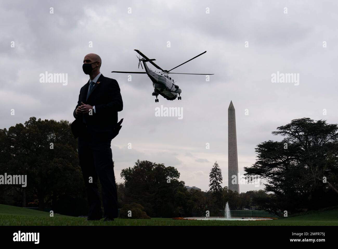 A U.S. Secret Service Special Agent stands as Marine One, with ...