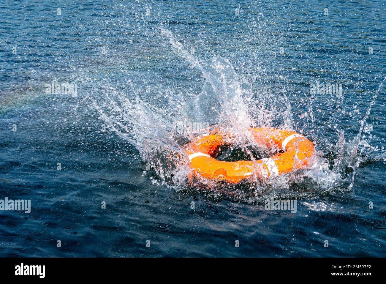 Orange lifebuoy in the sea on the water. The lifebuoy fell with a ...