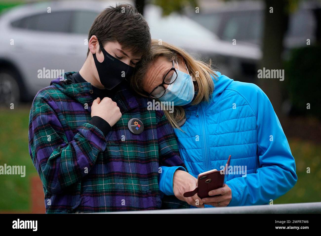 Amanda Godley, right, and her son Benjamin Godley-Fisher pause for a ...