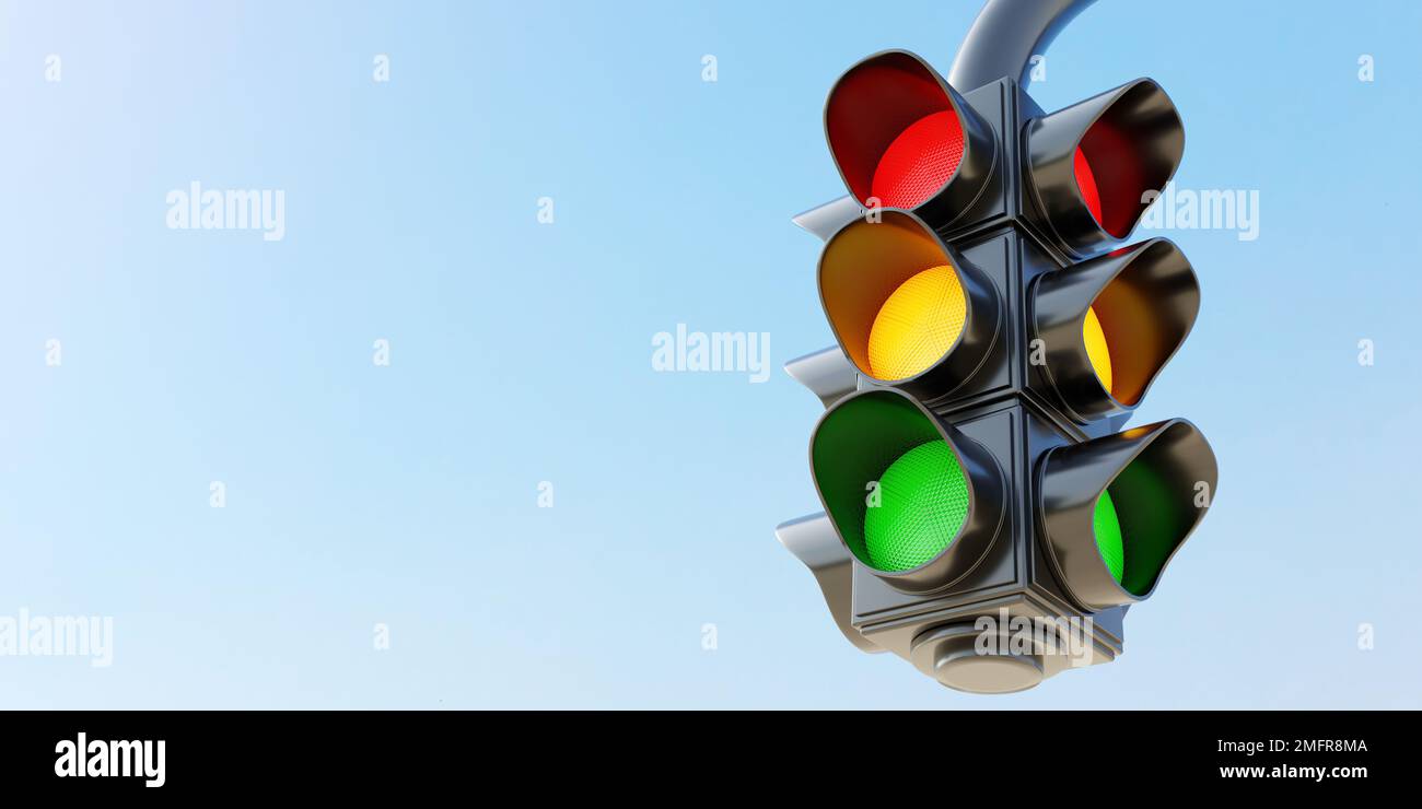 Double hanging traffic light with all three color on empty blue sky ...