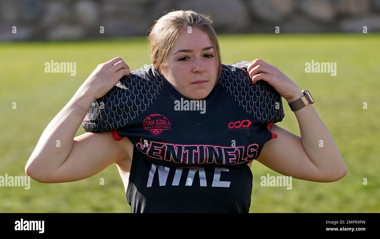 Sam Gordon puts on her shoulder pads, Oct. 20, 2020, in Herriman, Utah ...