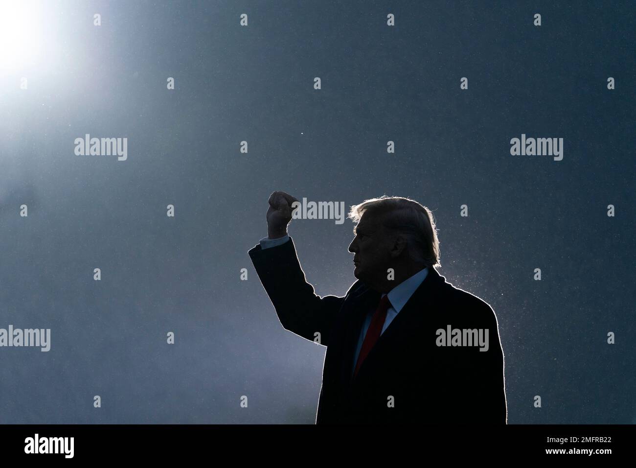 President Donald Trump pumps his fist as he departs after speaking at a ...