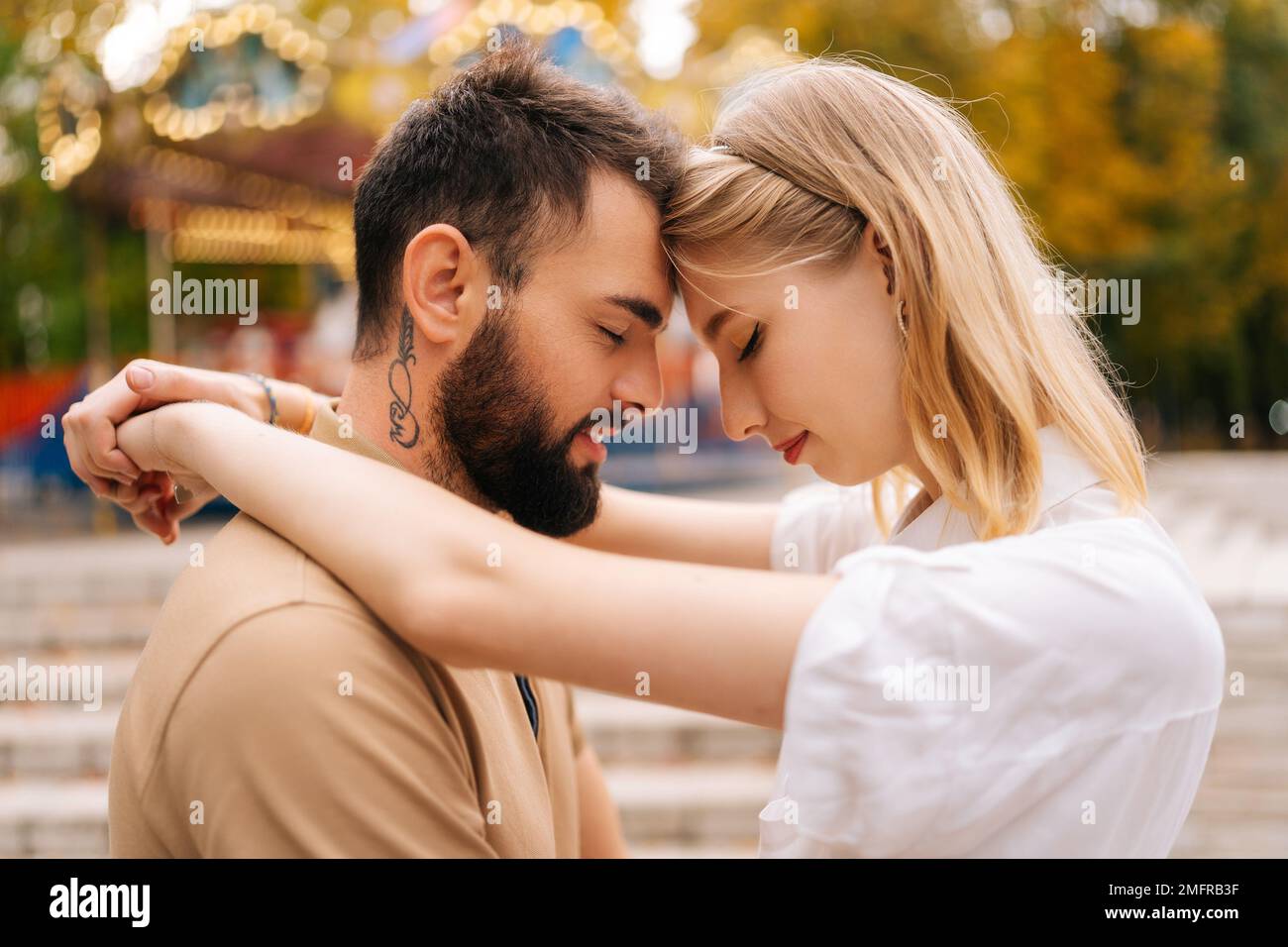 Close up of romantic young couple in love touching each other foreheads ...