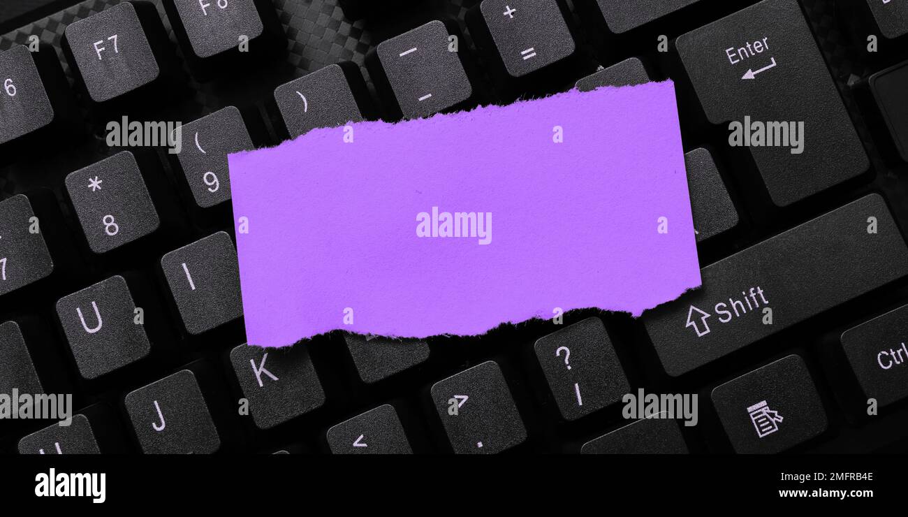 Sticker lying on black keyboard. Important message written over paper ...