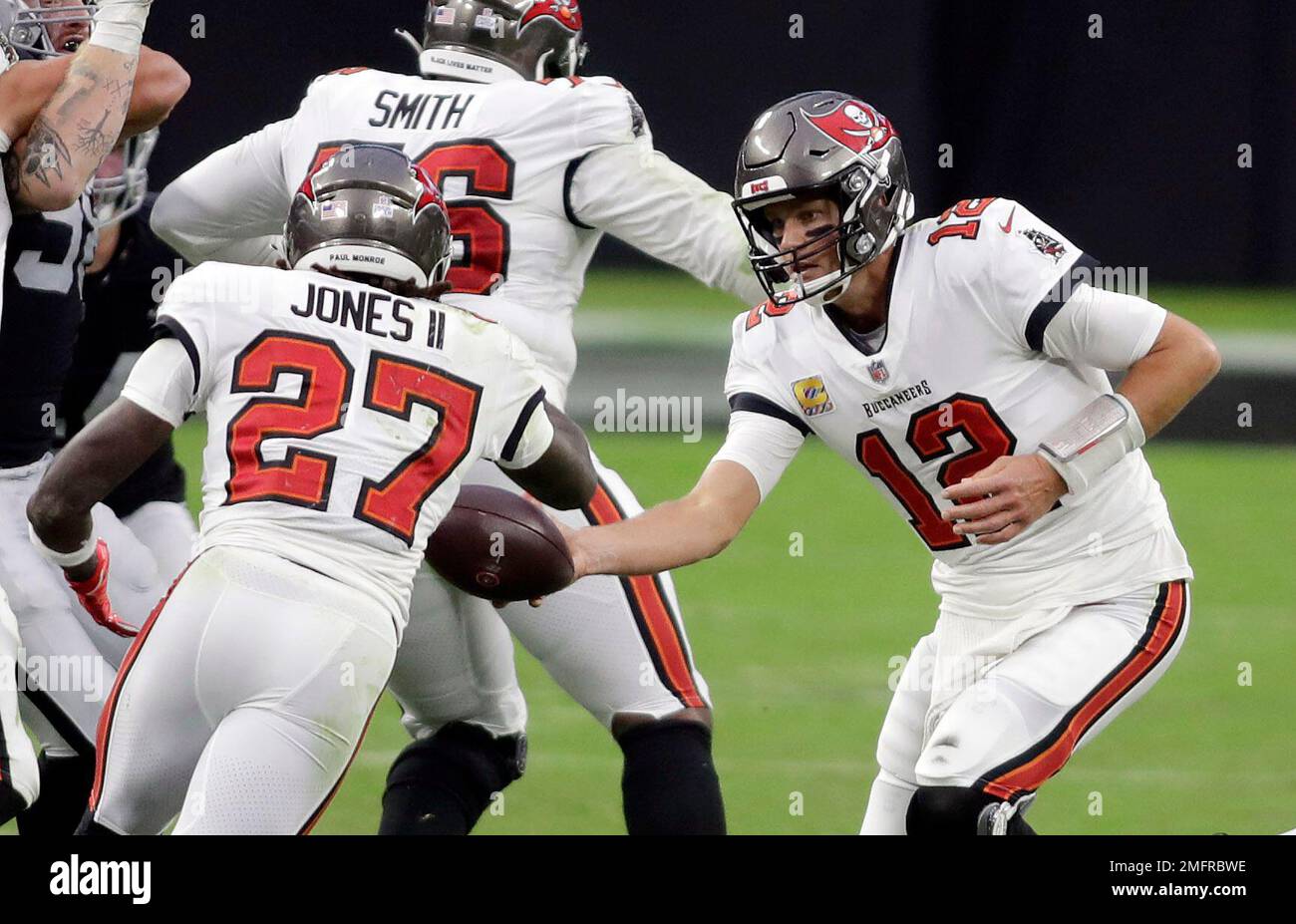 Buccaneer's quarterback Tom Brady (12) hands off to Ronald Jones Jr ...