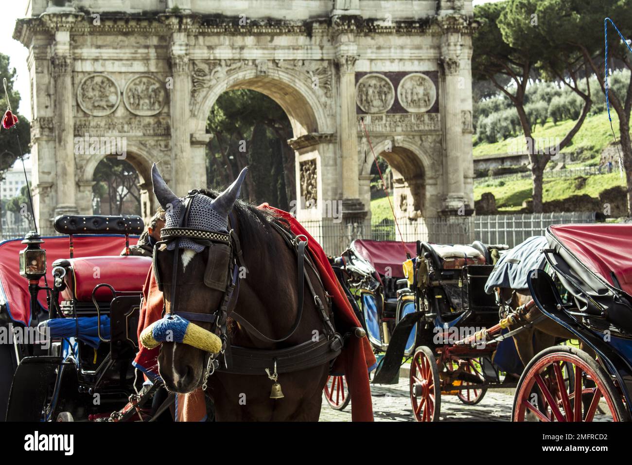 Carriages with horses in front of the Arch of Constantine in the ...