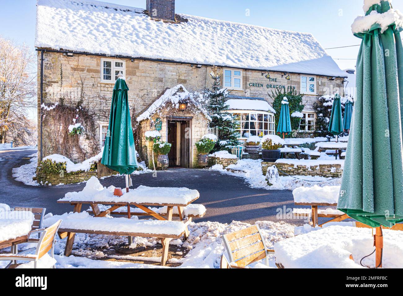 Early winter snow at The Green Dragon Inn Pub in the Cotswold village ...