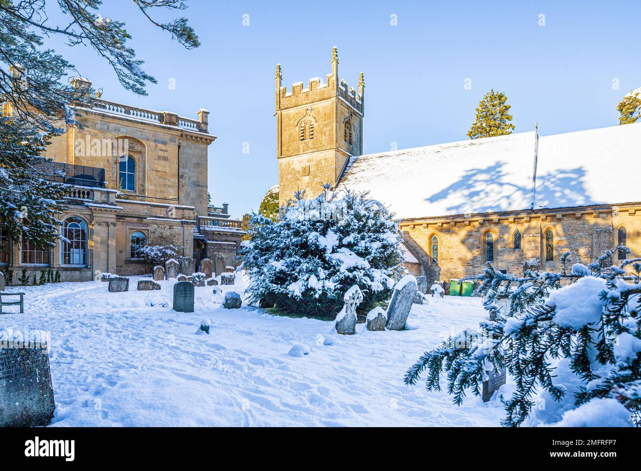 Early winter snow on the church of St Mary next to Cowley Manor Hotel ...
