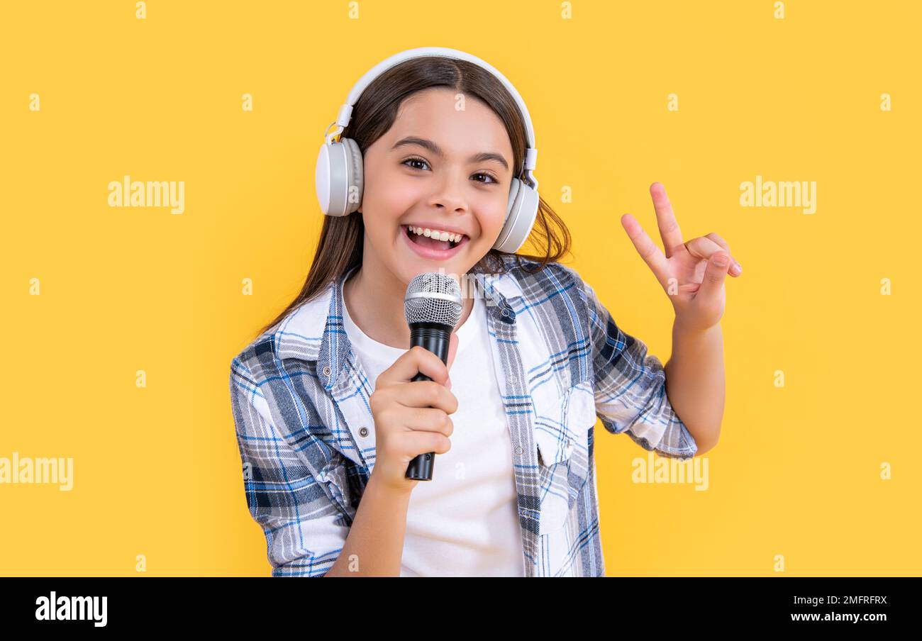 teen girl karaoke singer wear headphones isolated on yellow. teen girl ...