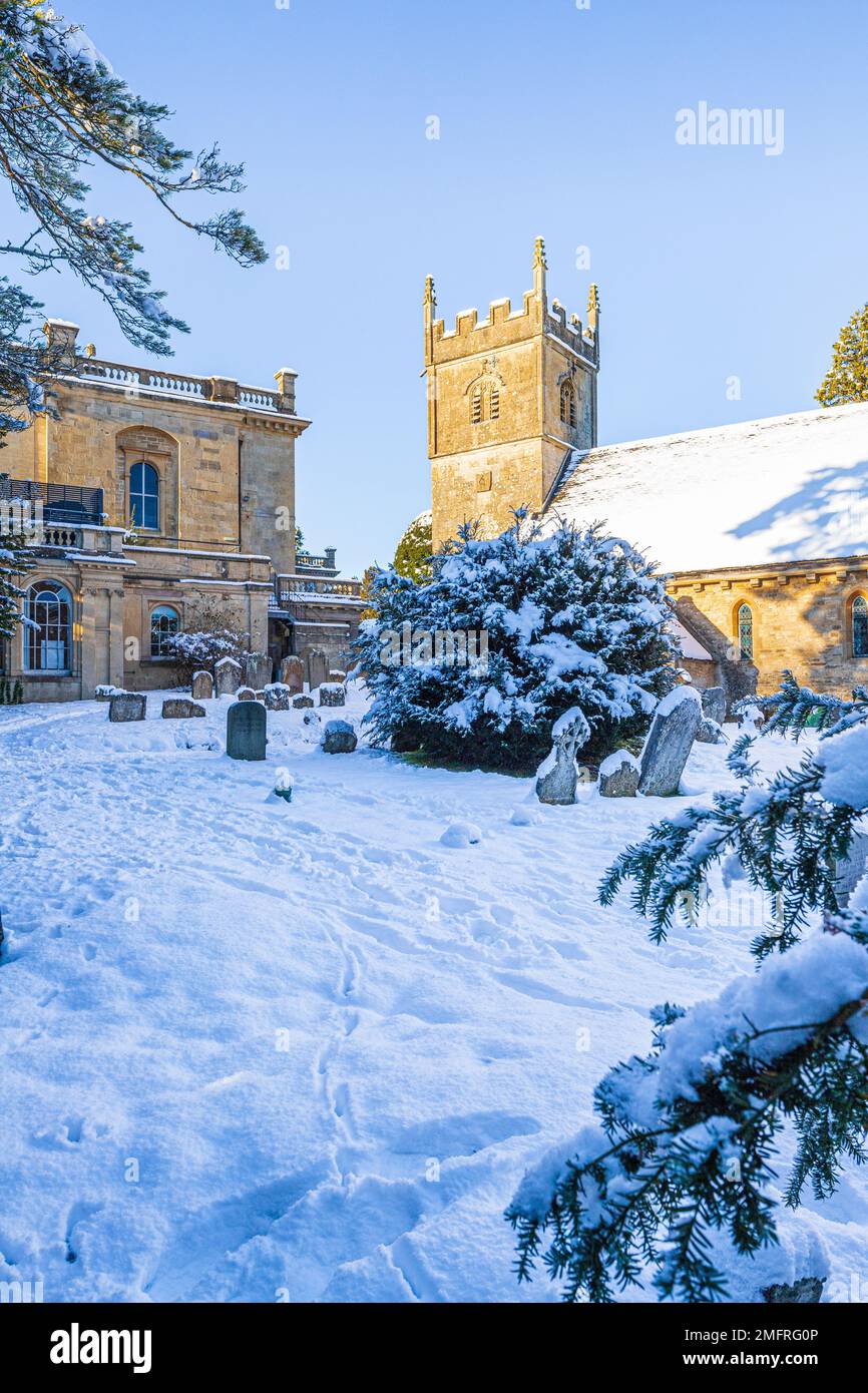 Early winter snow on the church of St Mary next to Cowley Manor Hotel ...