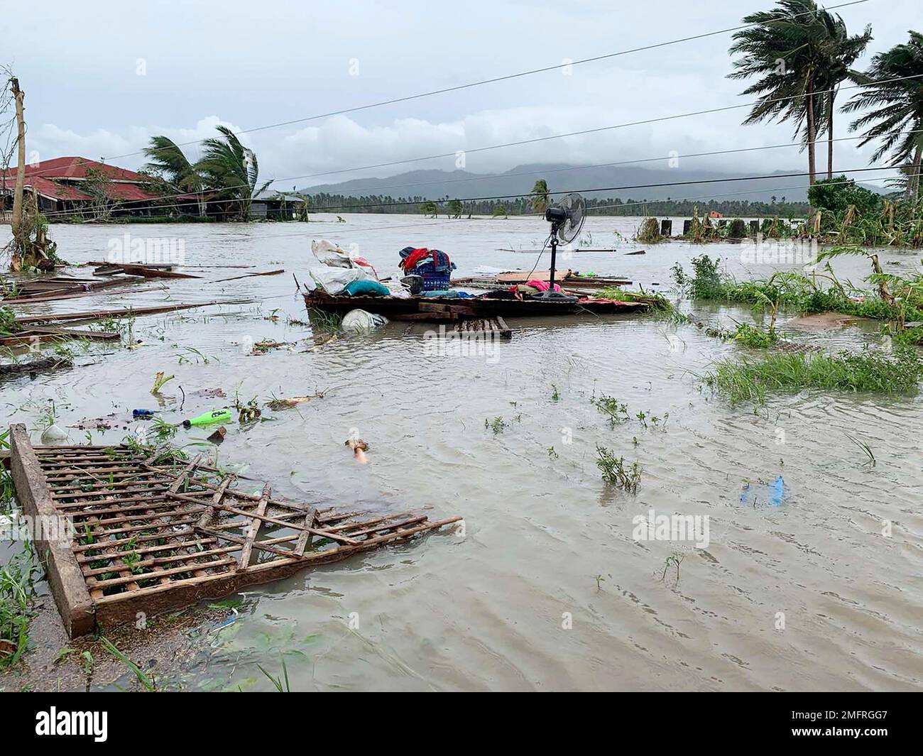 The remains of a house is surrounded by floods in Pola town on the ...