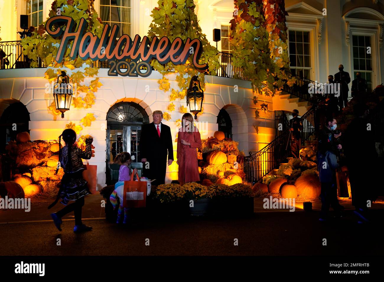 President Donald Trump and first lady Melania Trump greet trick-or ...