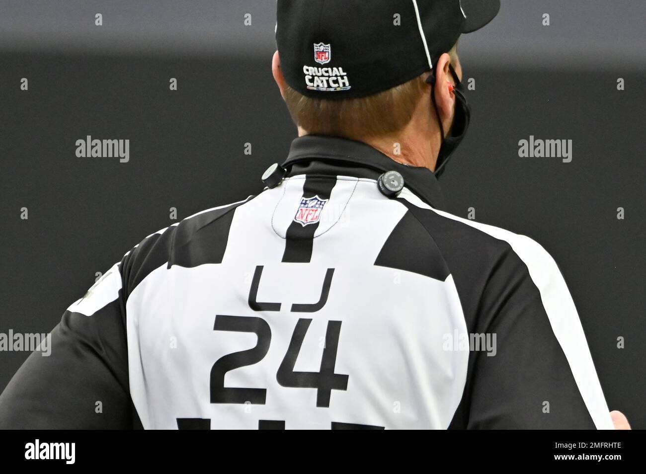 An official wears a "Crucial Catch" logo on his had before an NFL ...