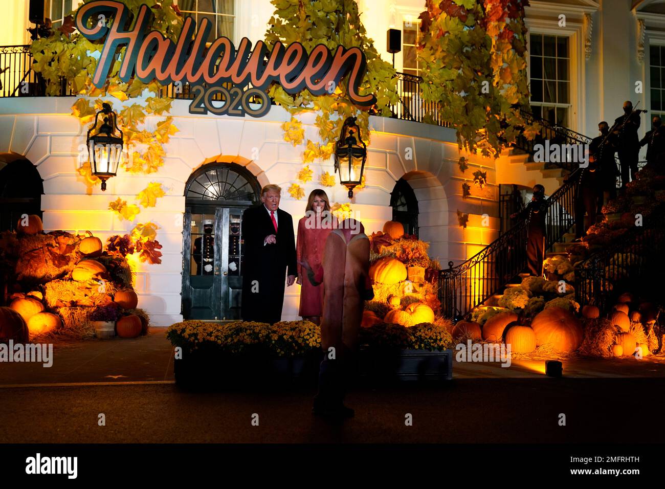 President Donald Trump and first lady Melania Trump greet trick-or ...