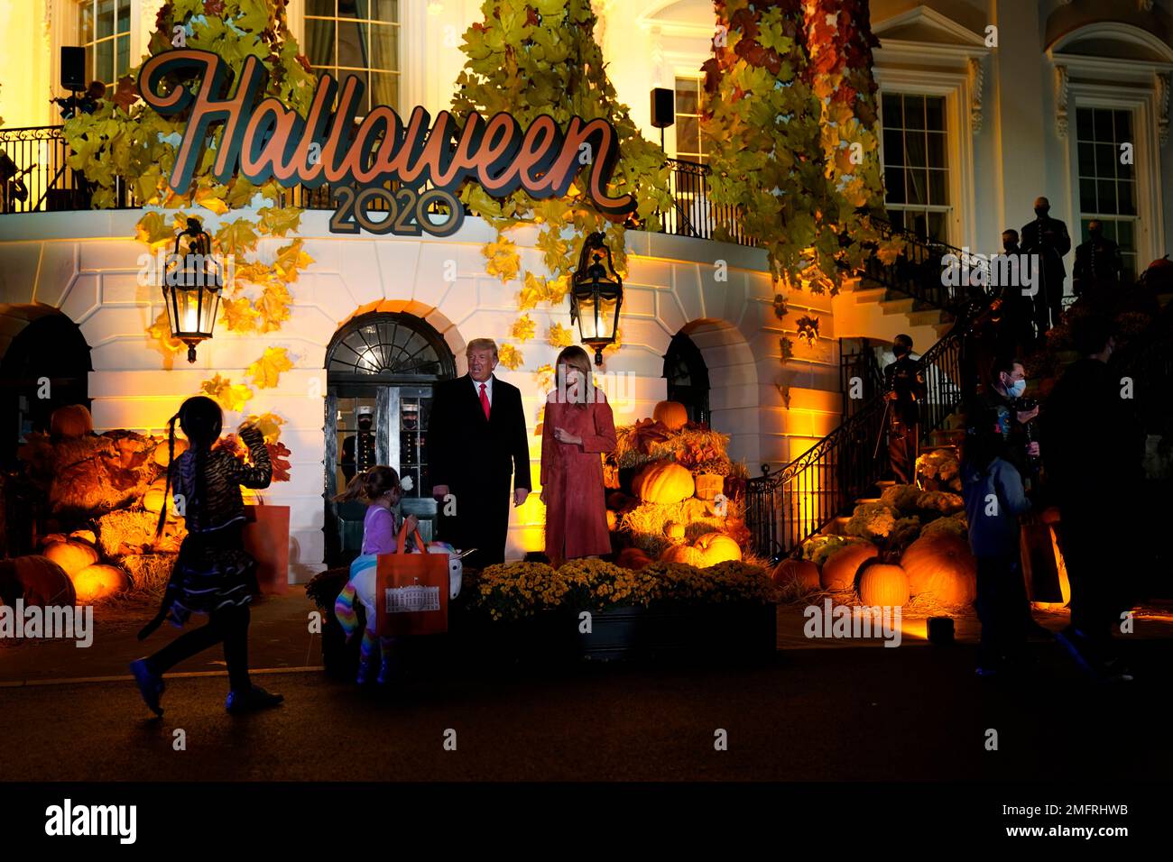 President Donald Trump and first lady Melania Trump greet trick-or ...