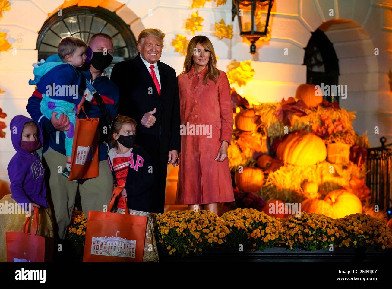 President Donald Trump and first lady Melania Trump greet trick-or ...
