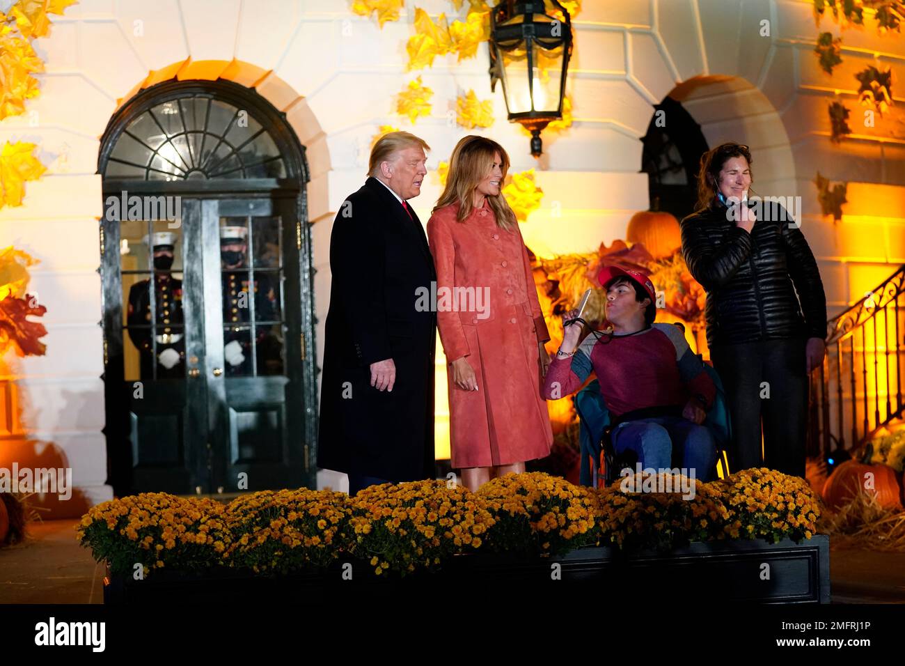 President Donald Trump and first lady Melania Trump greet trick-or ...