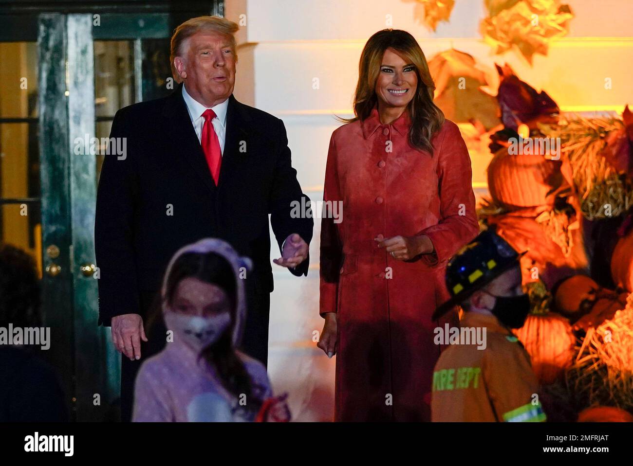 President Donald Trump and first lady Melania Trump greet trick-or ...