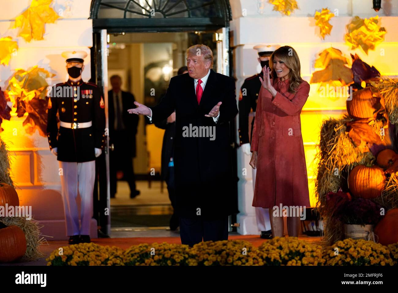 President Donald Trump and first lady Melania Trump greet trick-or ...