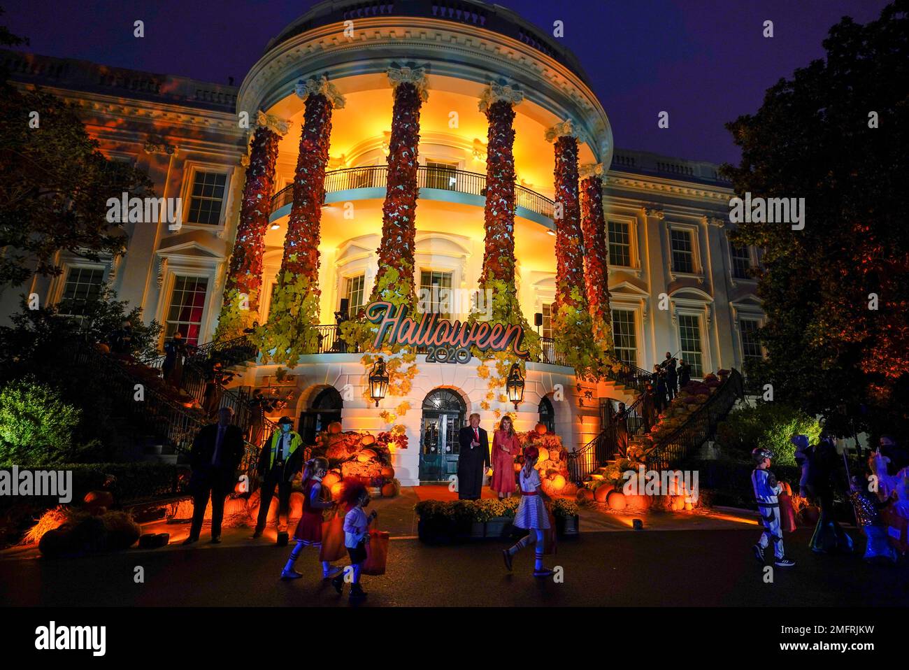 President Donald Trump and first lady Melania Trump greet trick-or ...