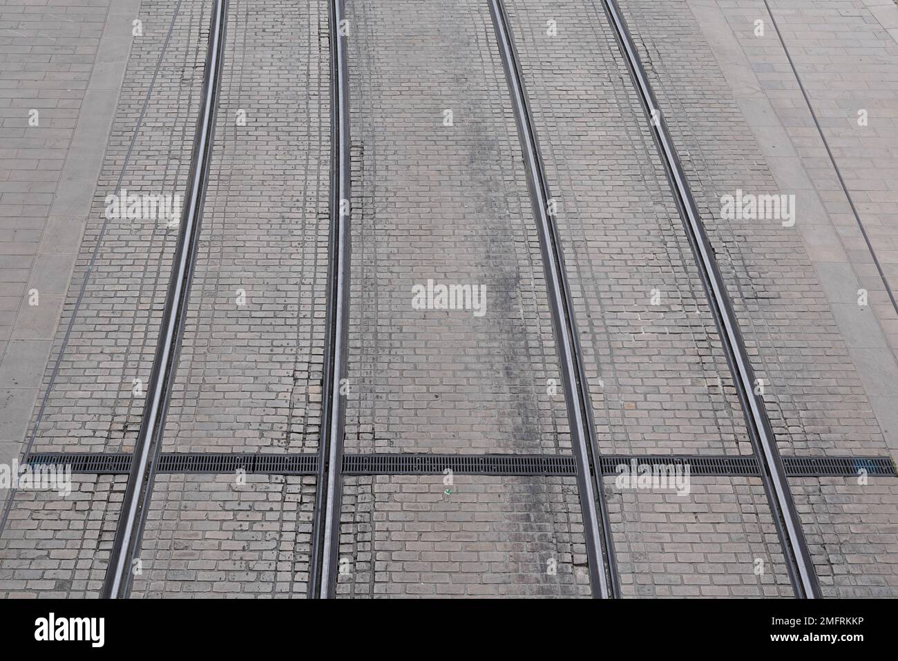 tram rails in the town line on gray pavement background transport ...