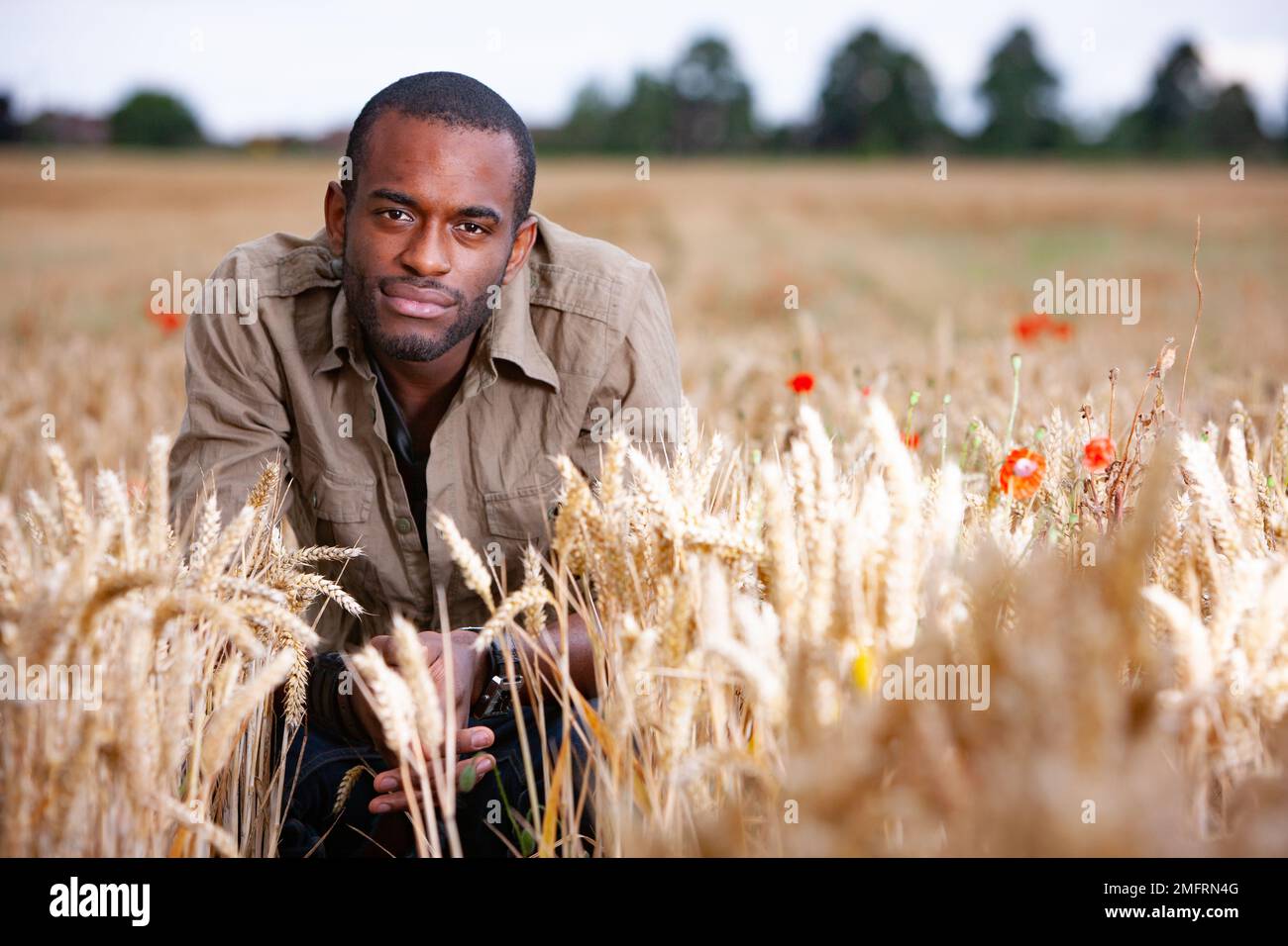 Rural Fashion, Ready for Harvest. A young farmer tending to his wheat ...