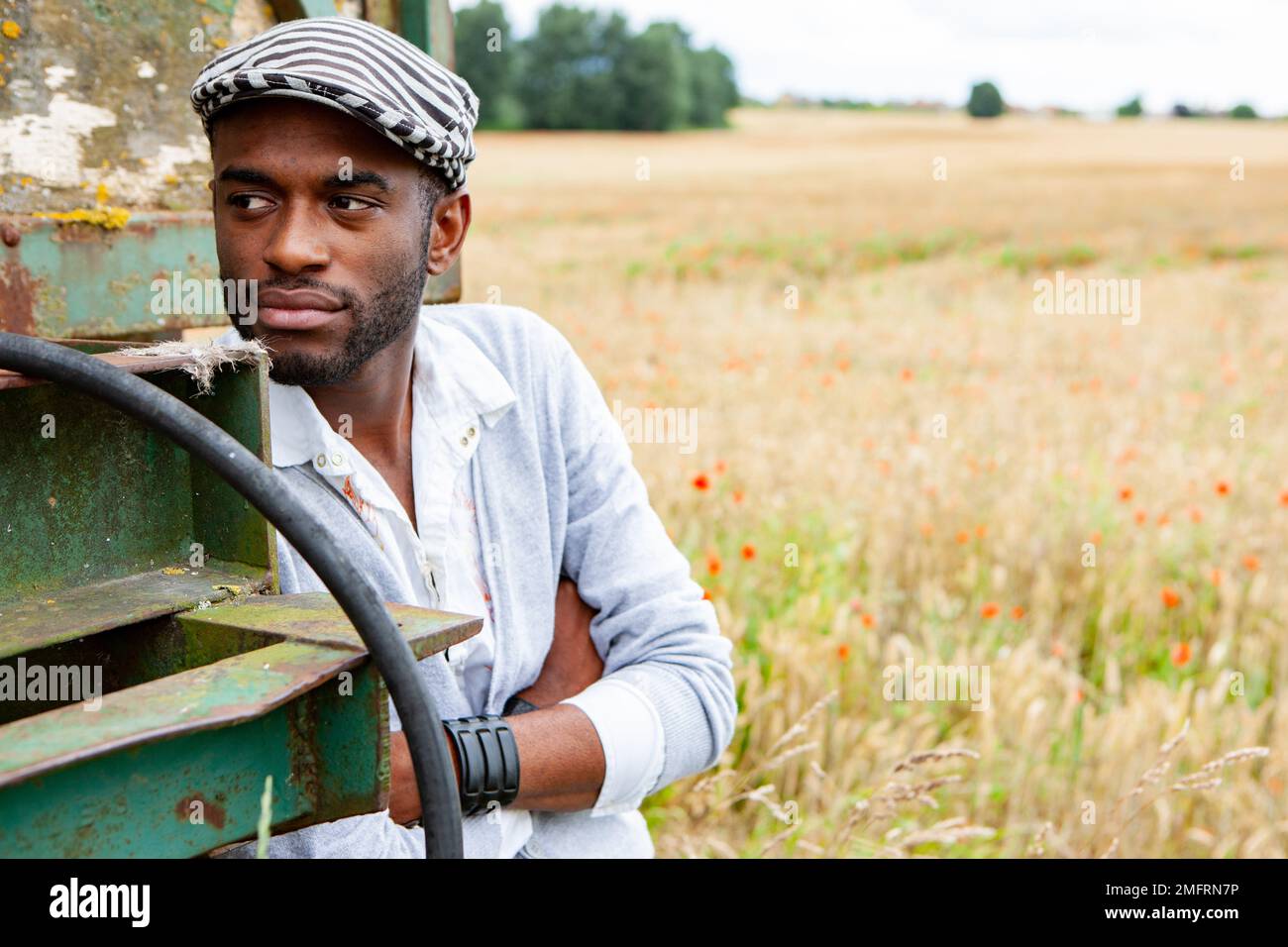 Rural Fashion, Farm Worker. A handsome young man standing in a rural ...