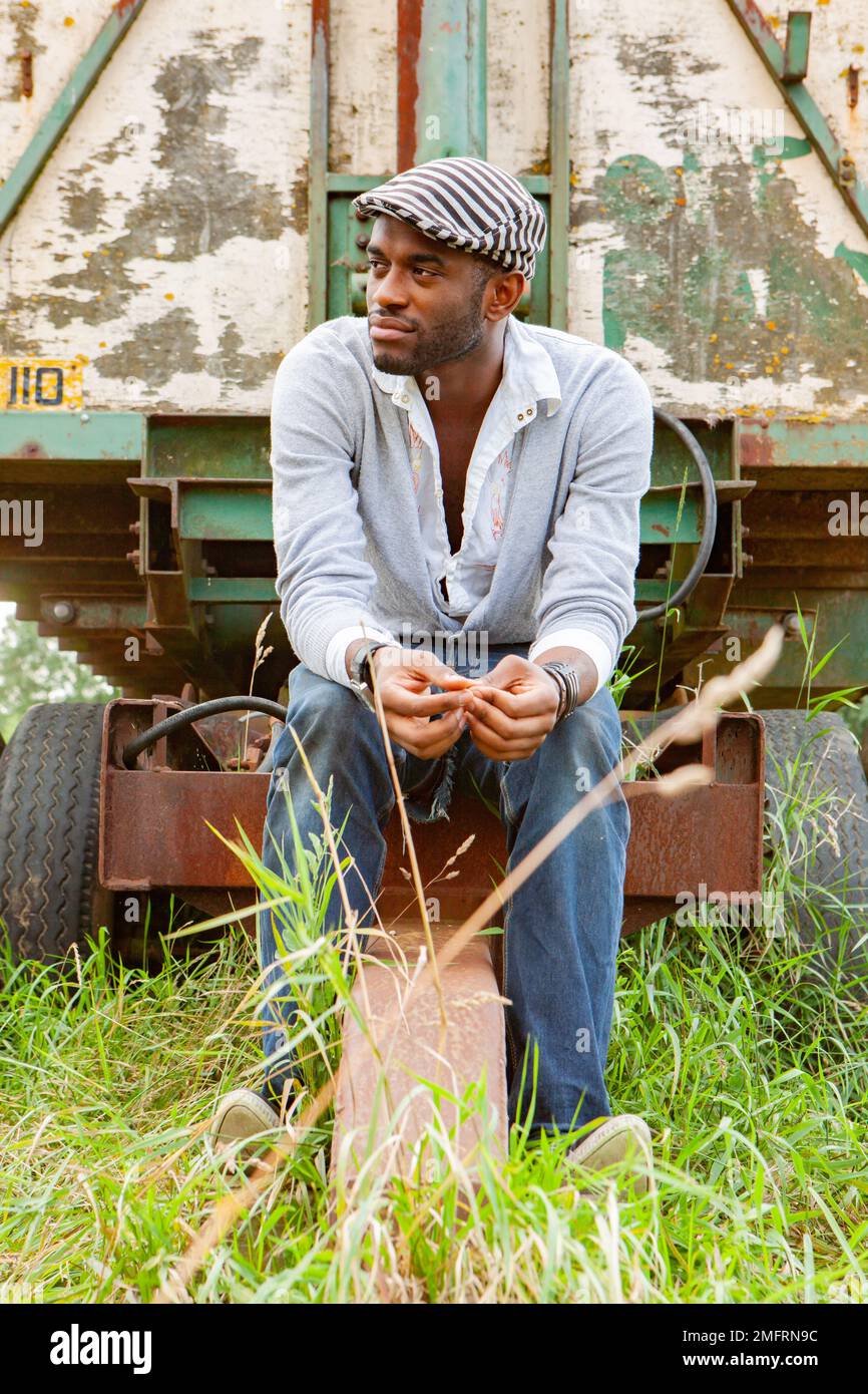 Rural Fashion, Farm Worker. A handsome young man waiting in a rural ...