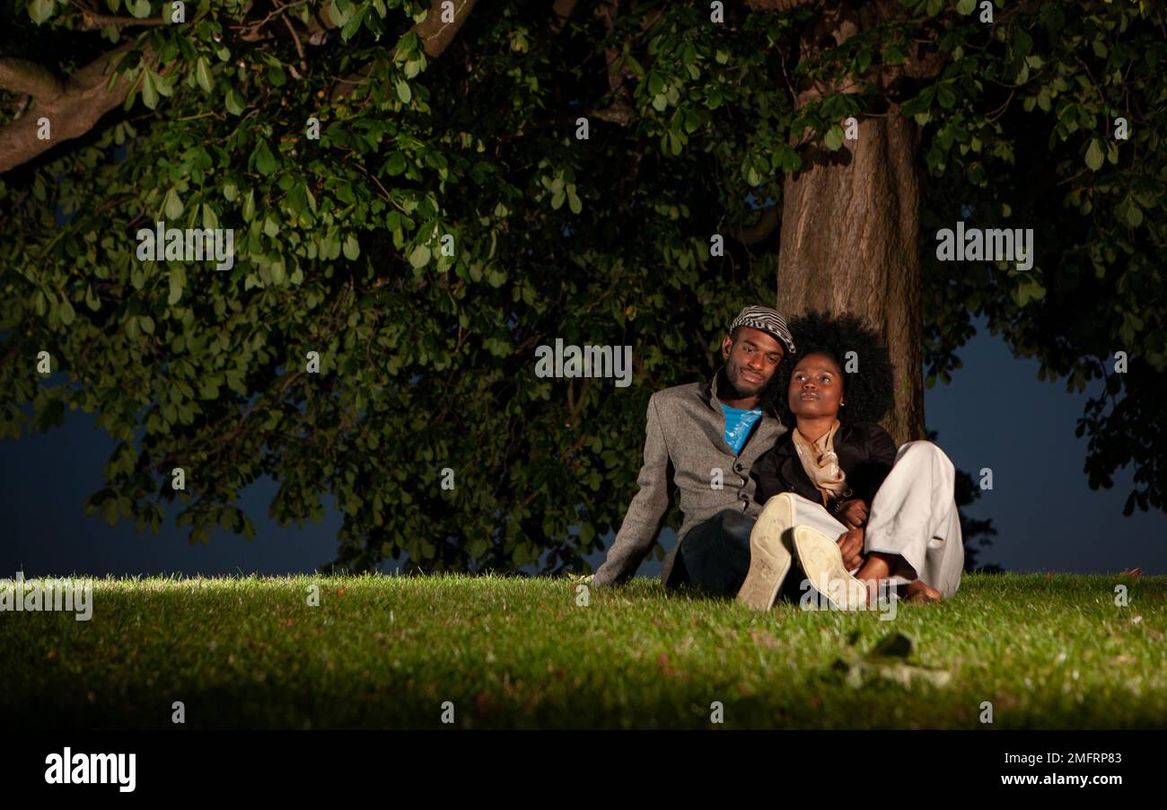 Togetherness. An intimate moment for a young couple enjoying an evening ...