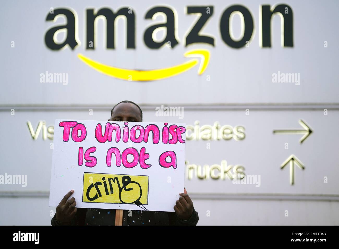 A member of the GMB union during a rally outside the Amazon fulfilment ...