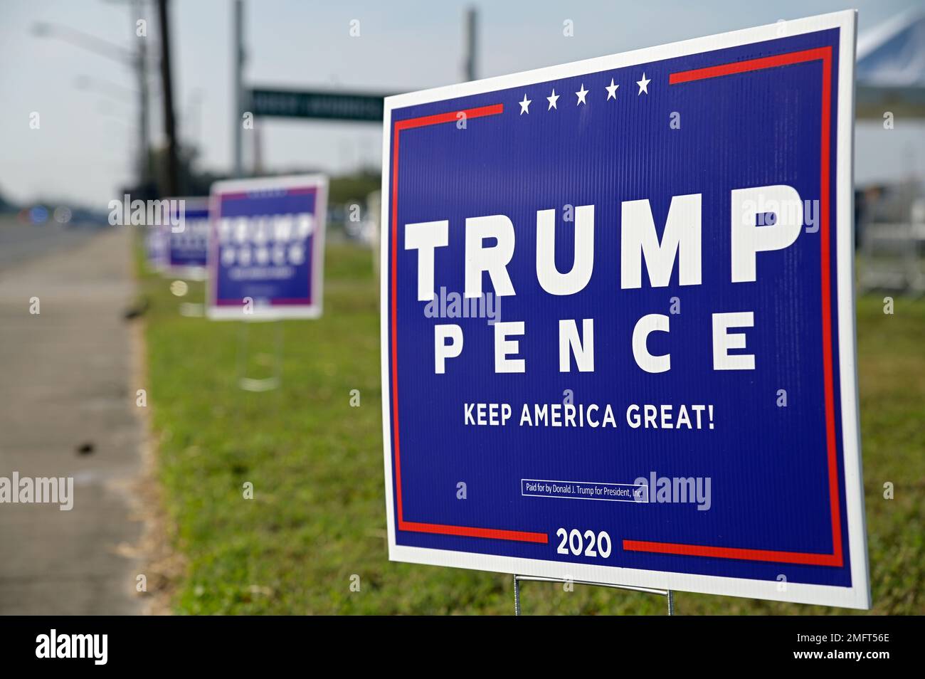 Signs supporting President Donald Trump are viewed alongside a road ...