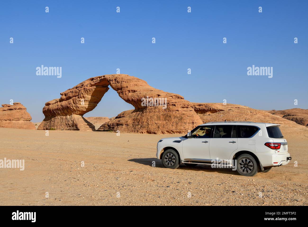 Car in front of The Arch, also known as Rainbow Rock, near AlUla ...