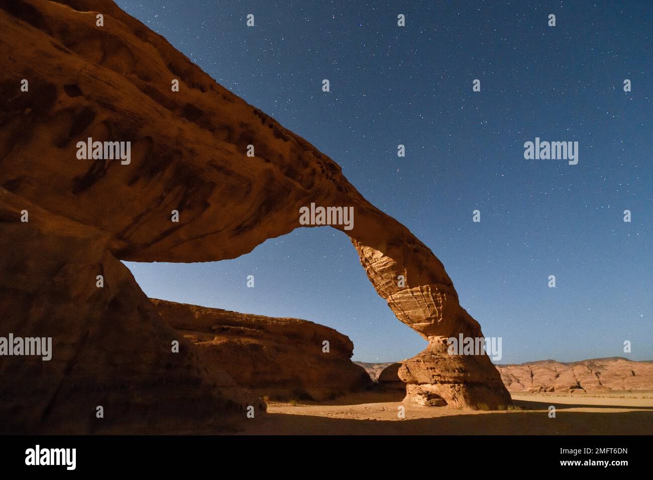 Starry sky above The Arch, also known as Rainbow Rock, near AlUla ...