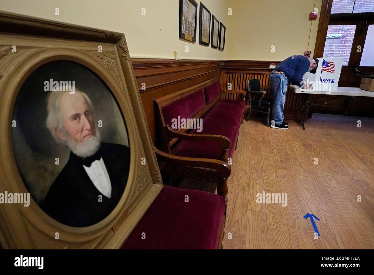 A voter marks his ballot at Lawrence City Hall during early in-person ...