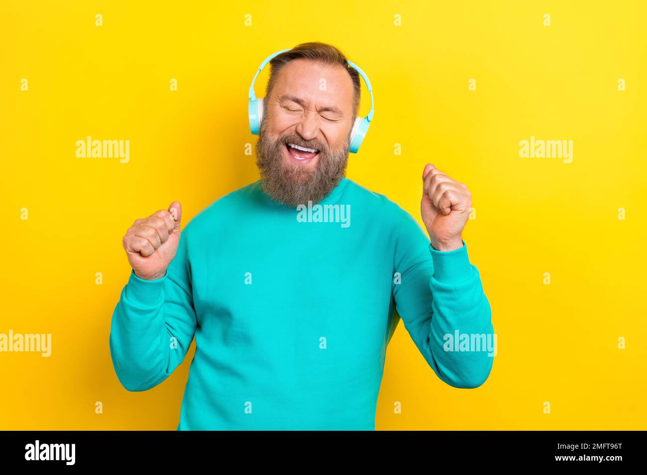 Photo portrait of handsome granddad raise fists dancing singing ...
