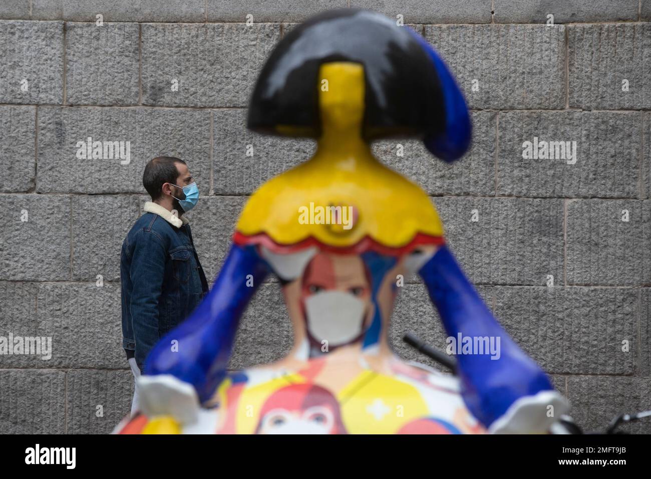 A man wearing a face mask to protect against the spread of coronavirus ...