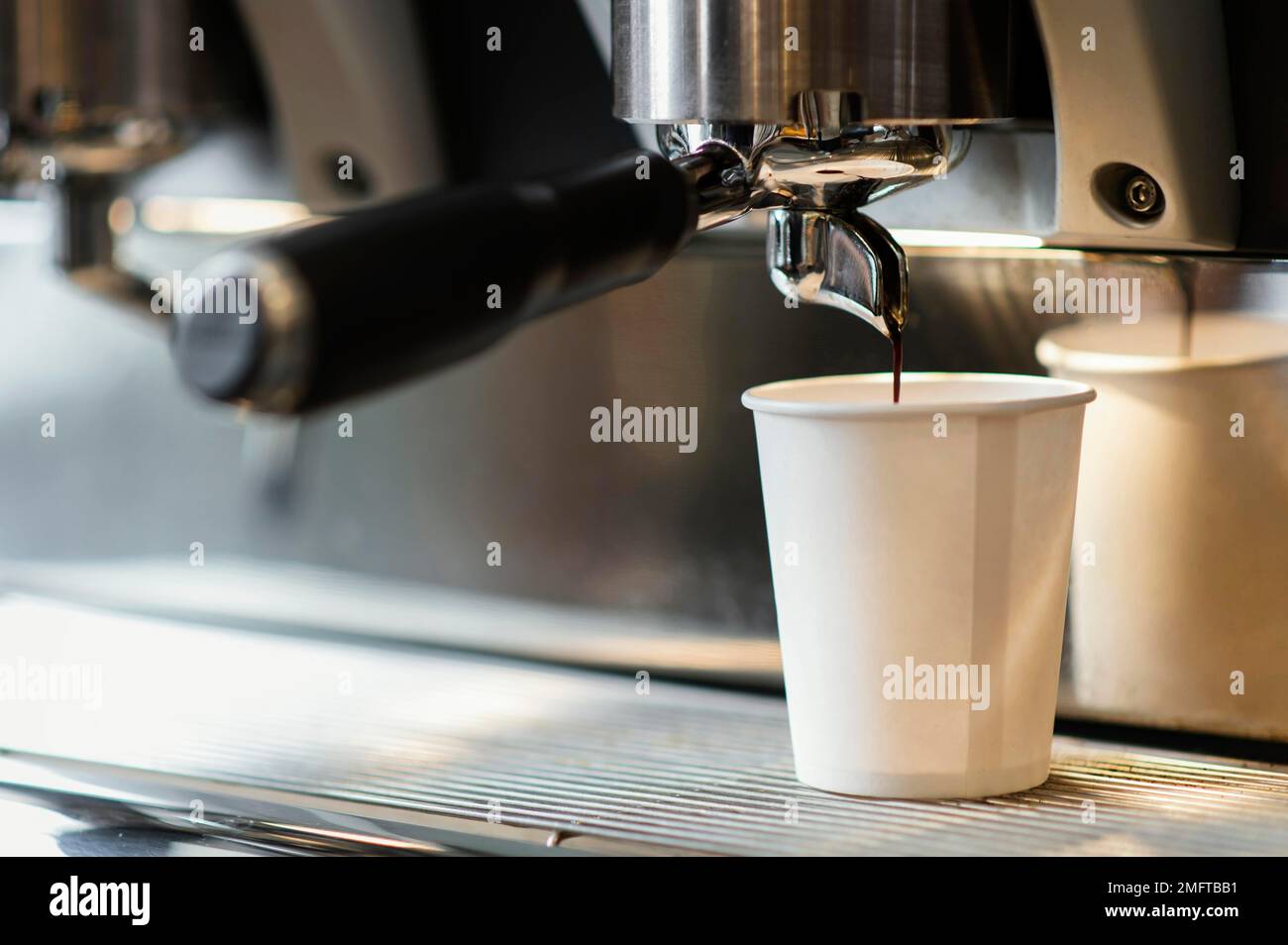 machine pouring coffee disposable cup Stock Photo - Alamy