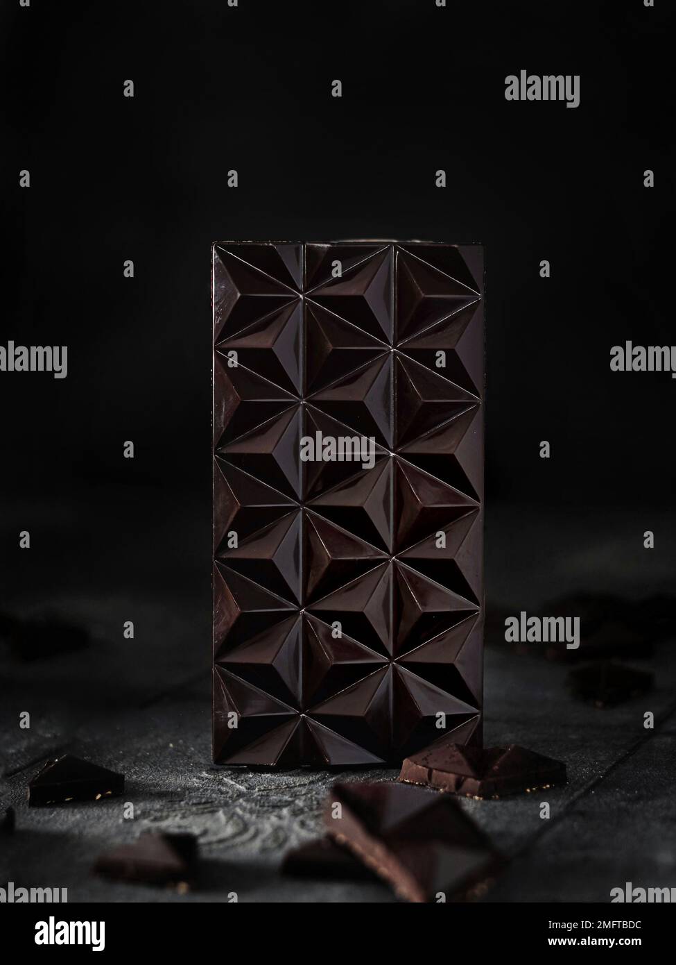 A vertical top view of a gourmet dark chocolate bar with a triangular ...