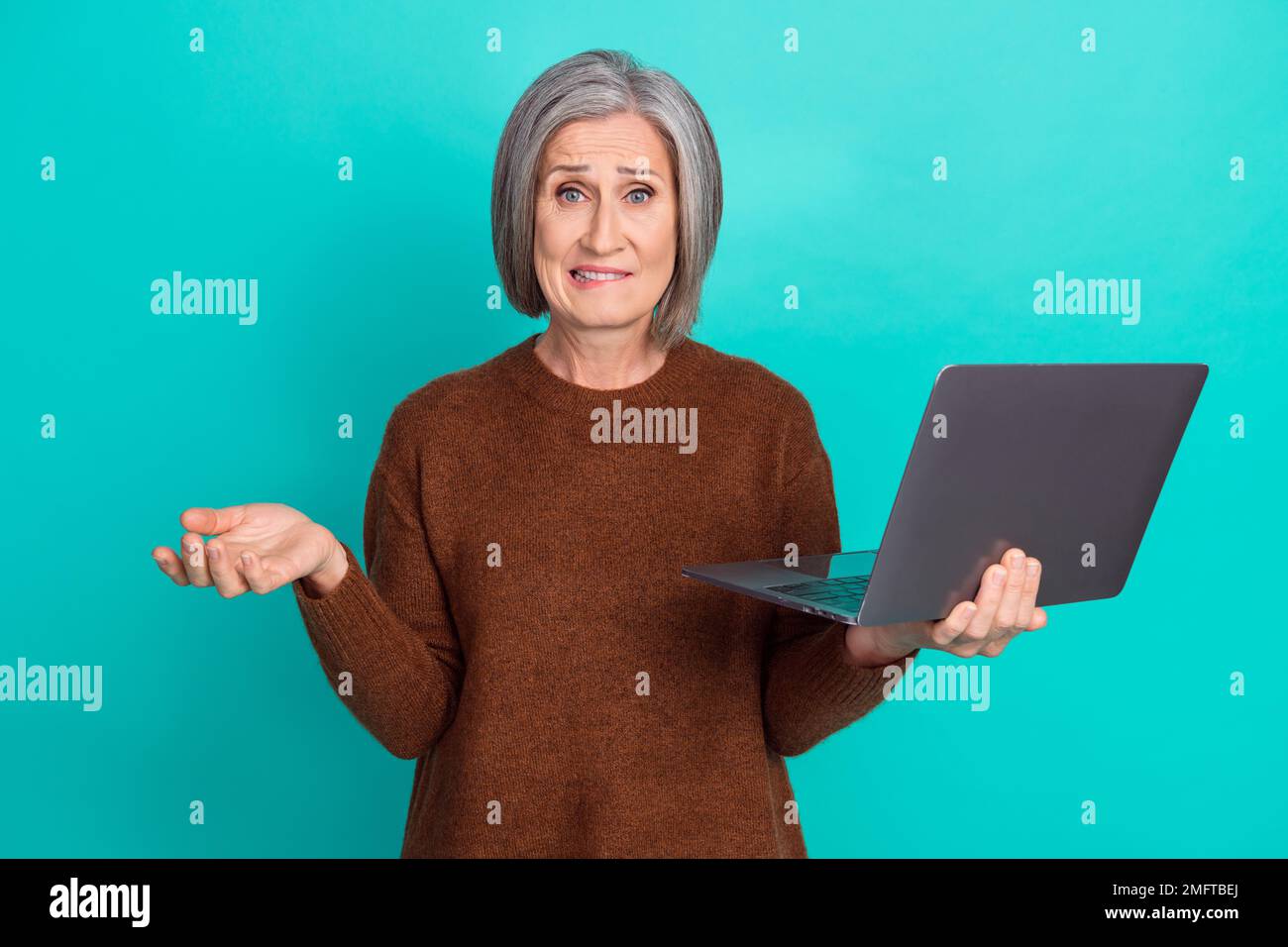 Photo of nervous worried lady biting lips hold wireless netbook ...
