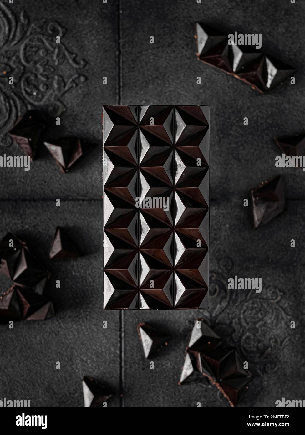 A vertical top view of a gourmet dark chocolate bar with a triangular ...