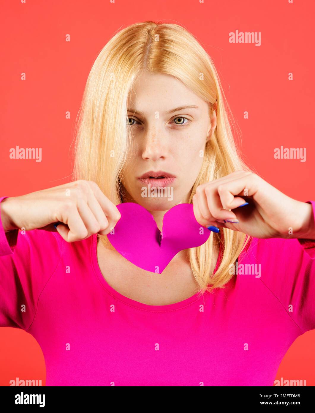 Sad girl with red broken paper heart. Relationship problems. Break of ...