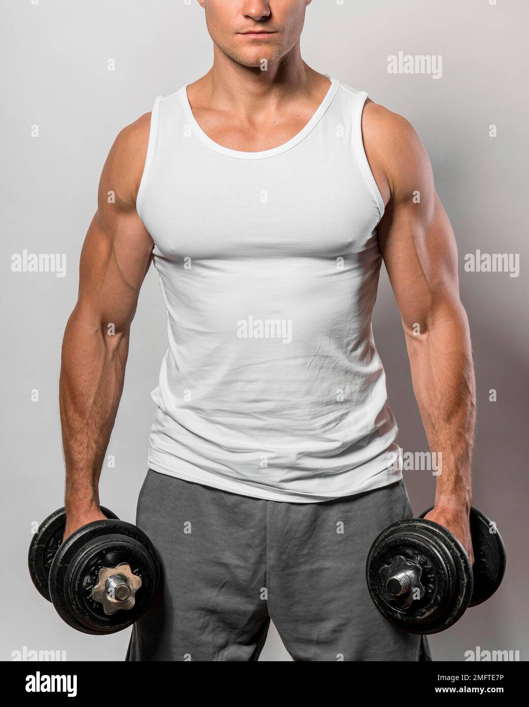 front view fit man with tank top weights Stock Photo - Alamy