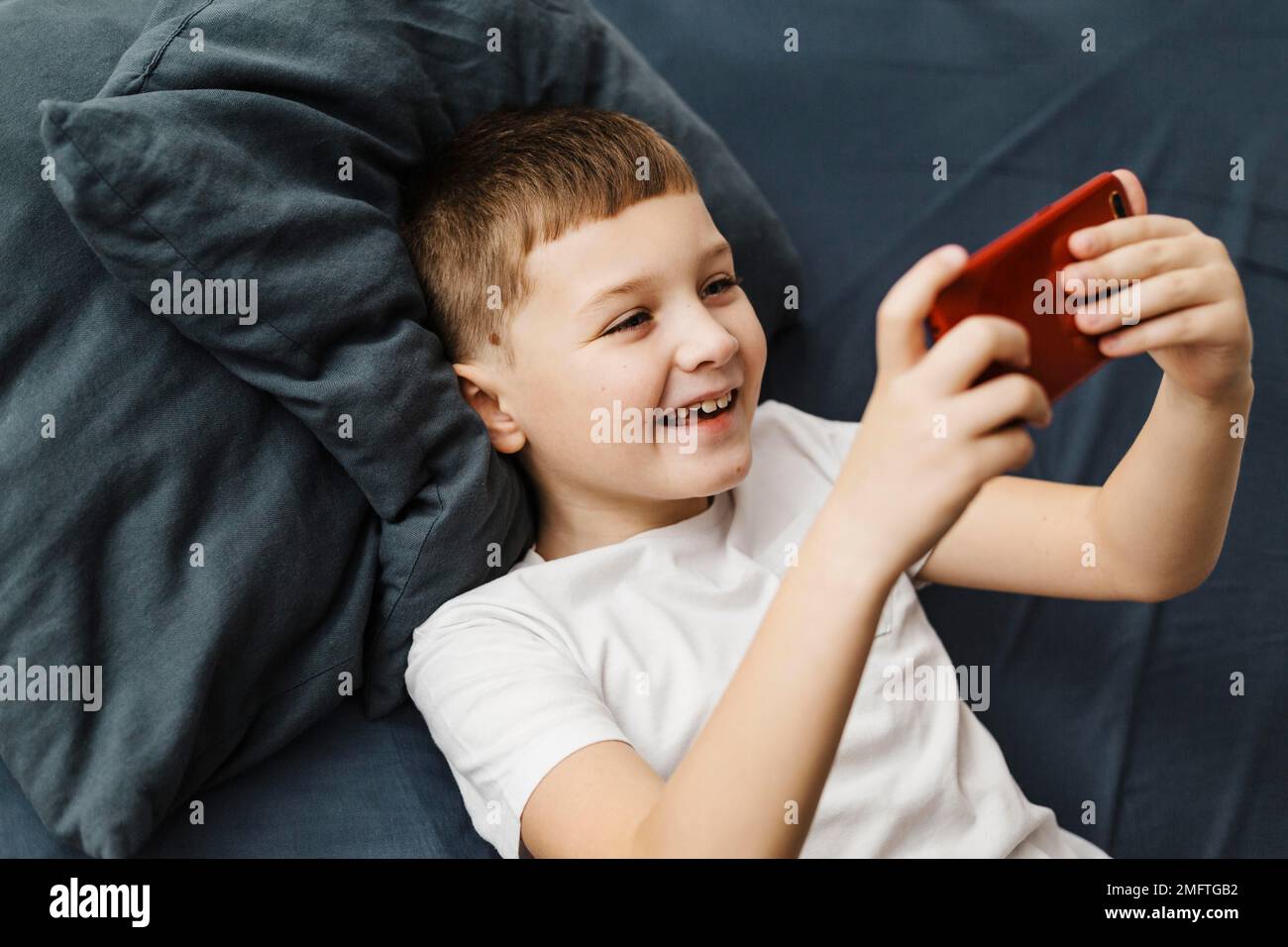 high view child playing mobile phone Stock Photo - Alamy