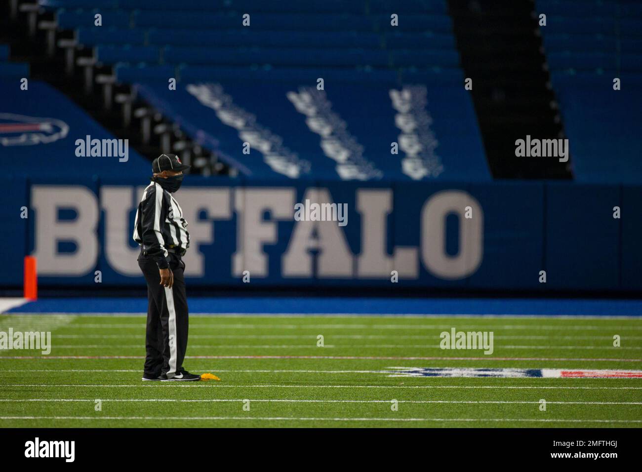 A referee stands over a penalty flag on the field during the second ...