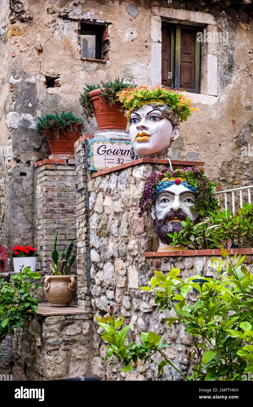 Courtyard in one of the alleys of the tourist destination of Taormina ...